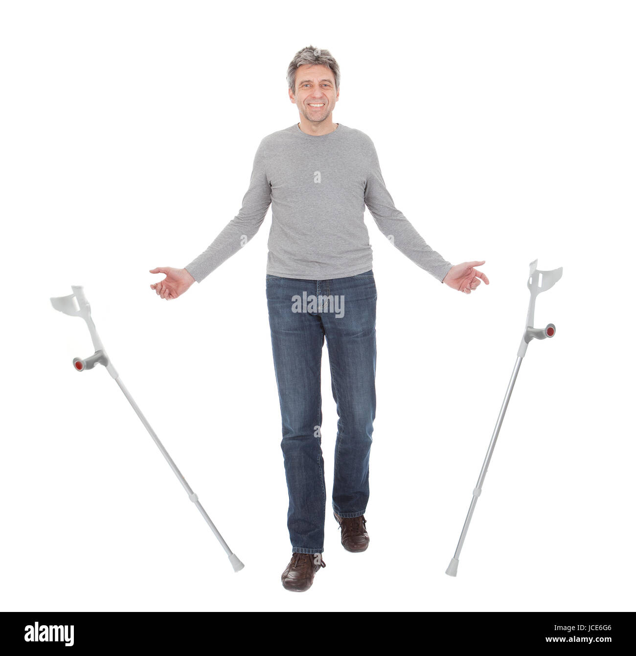 Senior man walking using crutches. Isolated on white Stock Photo - Alamy