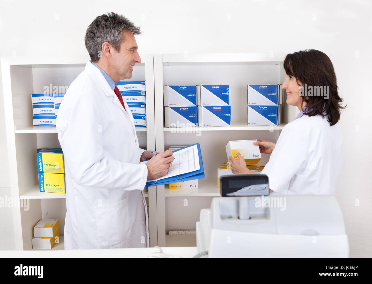 Two pharmacists checking drugs at the drugstore Stock Photo - Alamy