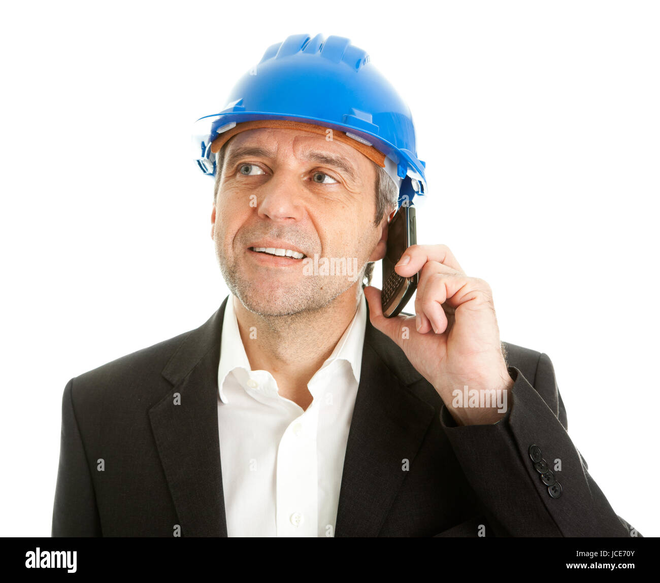 Portrait of architect wearing blue hard hat and talking on mobile phone ...