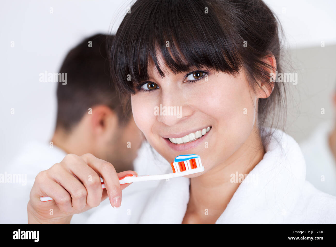 Young couple brushing teeth together at home in the bathroom Stock ...