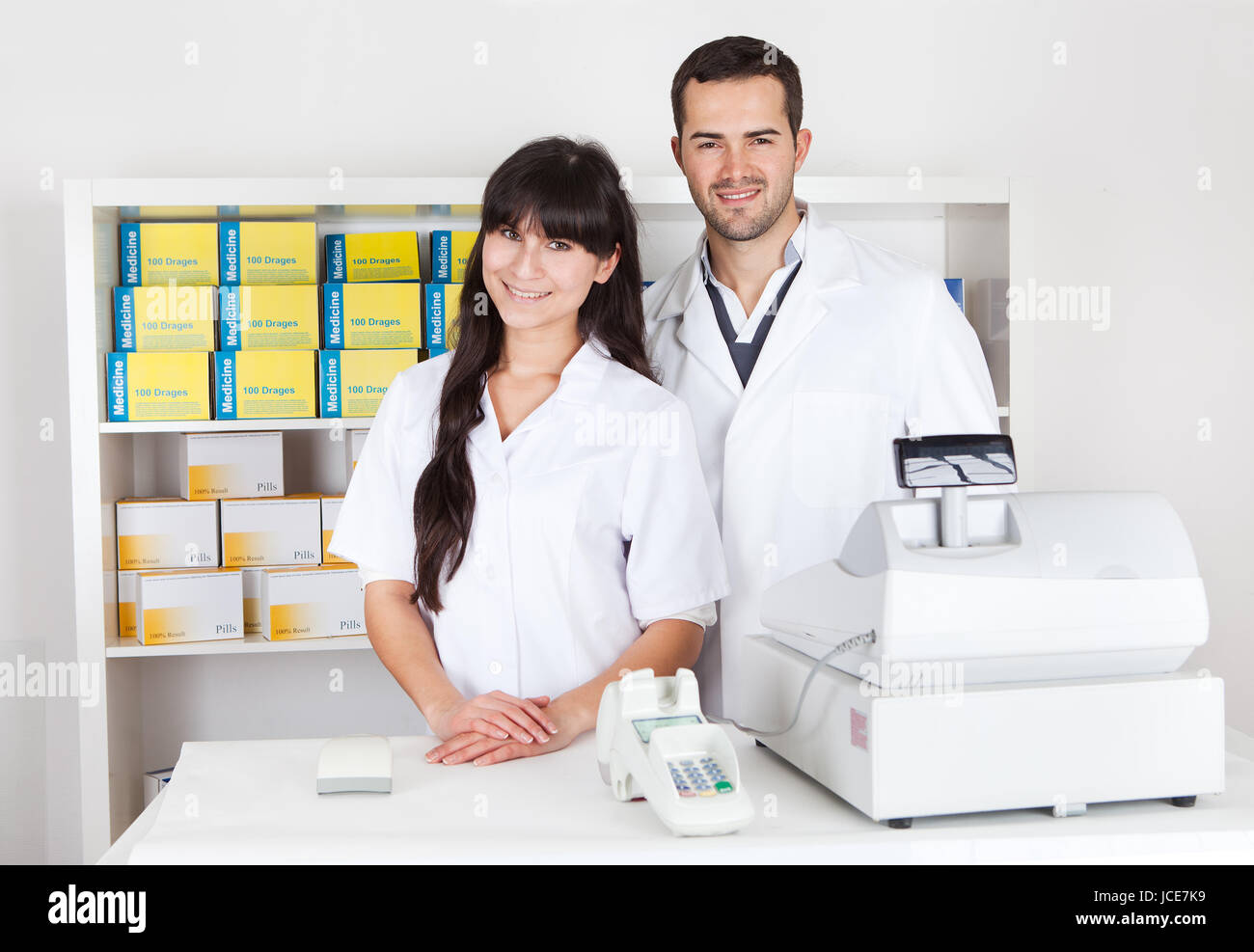 Portrait of two pharmacists at the drugstore smiling Stock Photo - Alamy