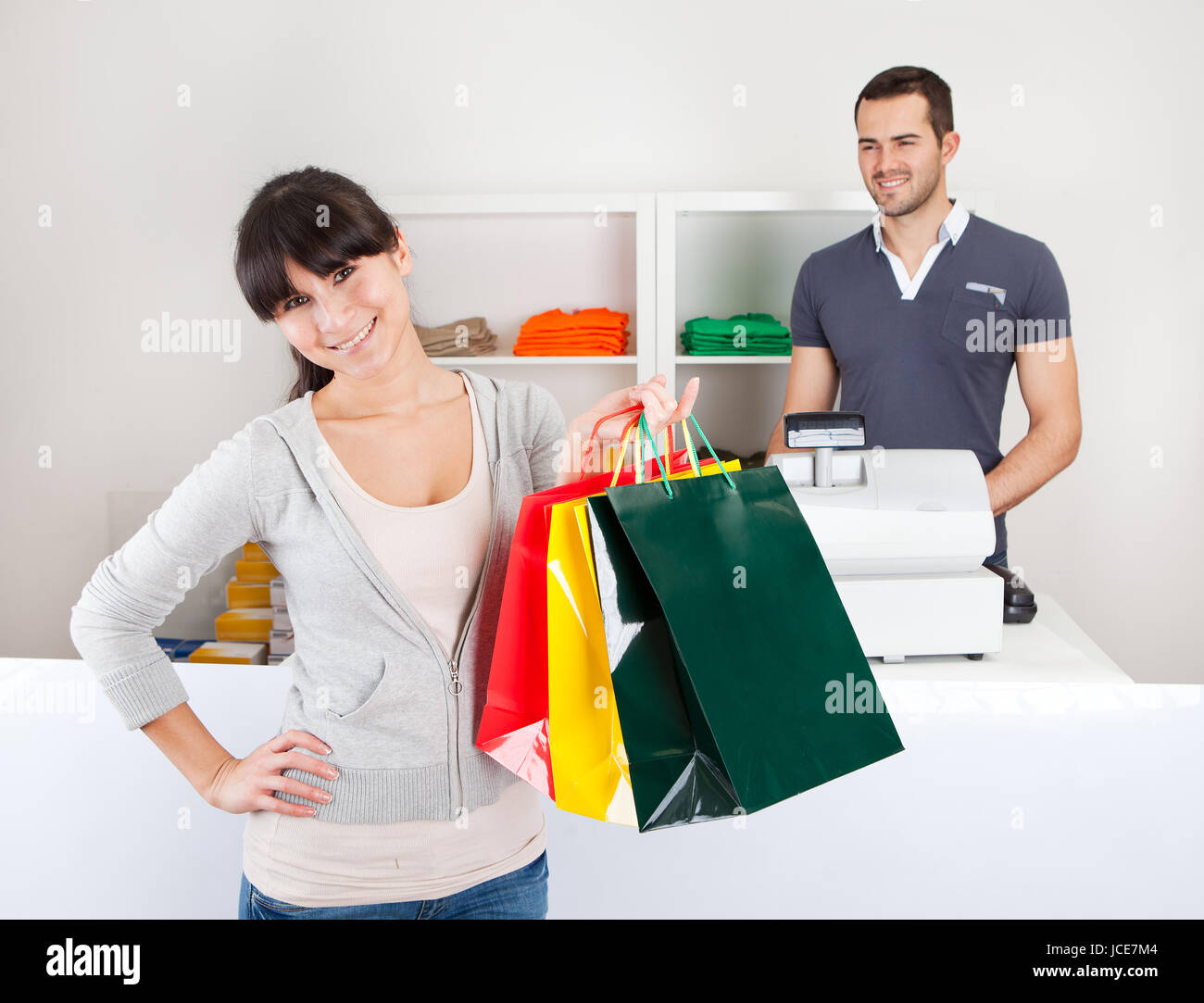 Female customer buying clothes at retail store Stock Photo - Alamy