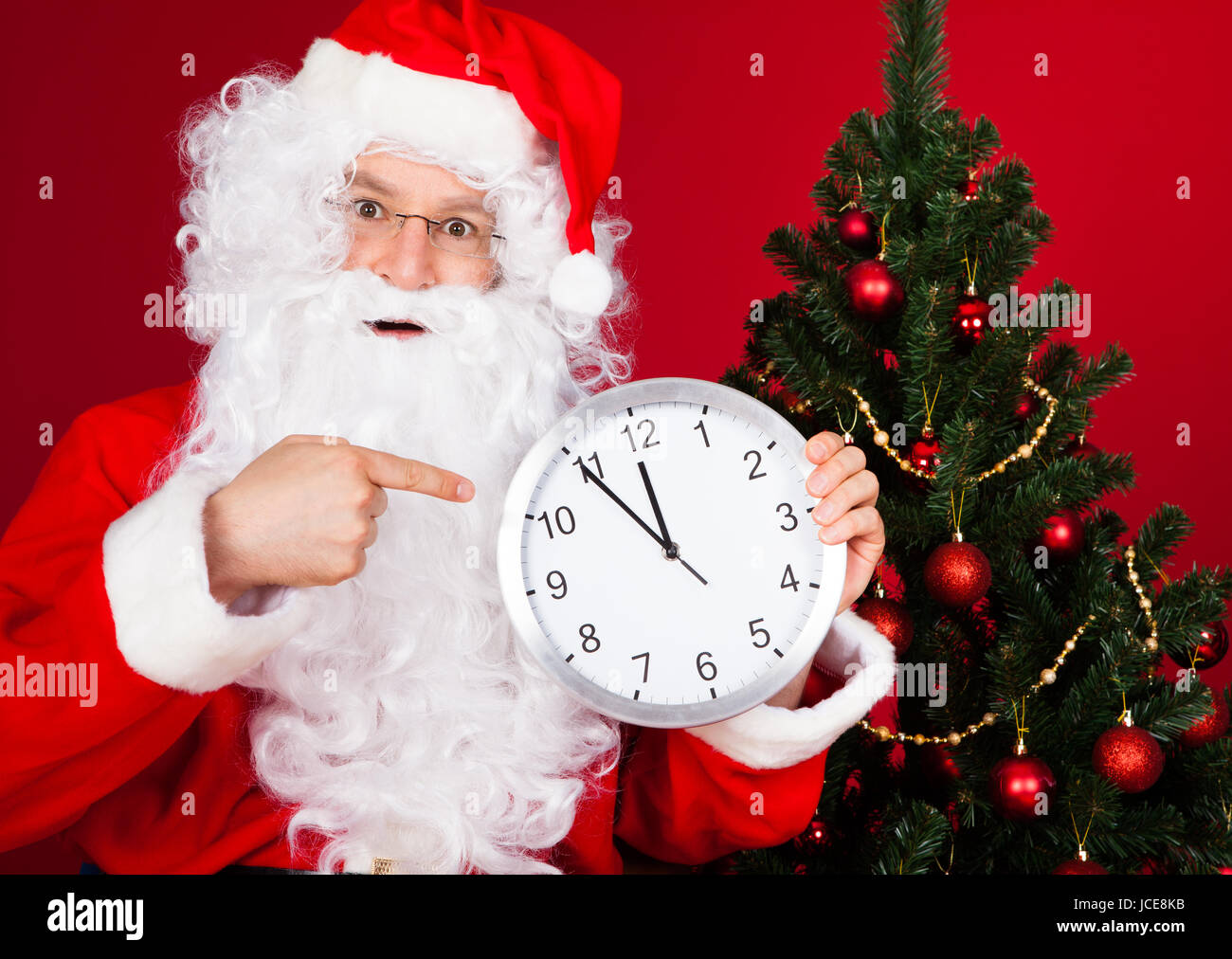 Happy santa pointing clock showing hi-res stock photography and images ...