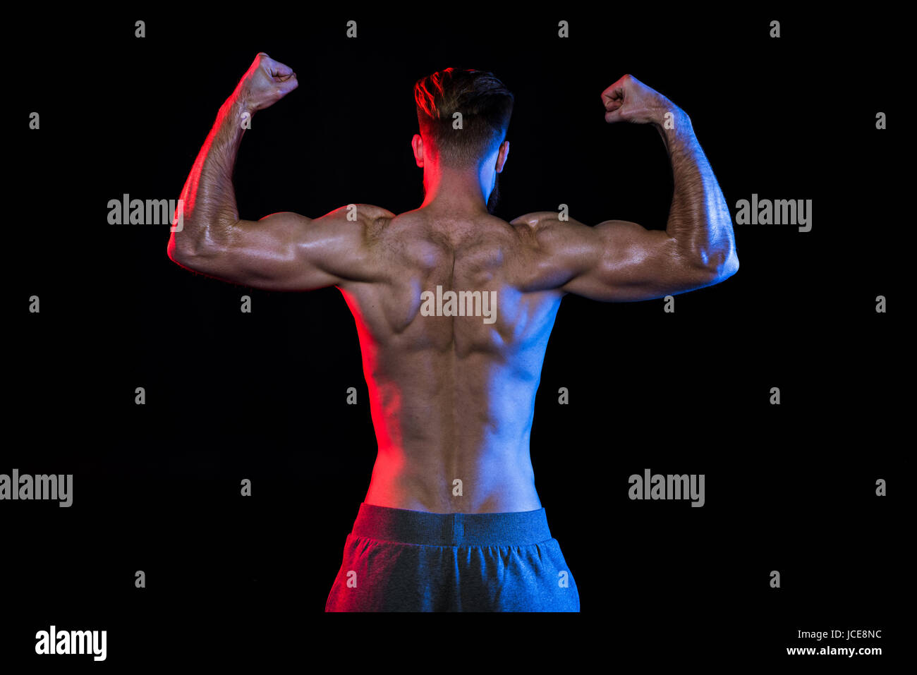 back view of shirtless bodybuilder gesturing isolated on black with ...