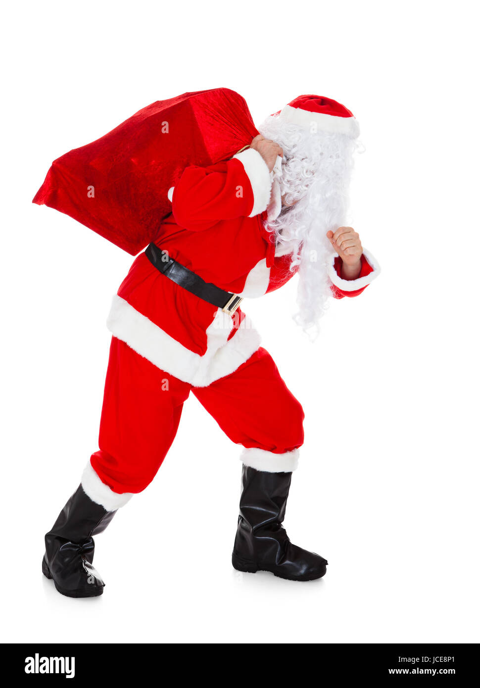 Portrait of santa carrying sack over white background Stock Photo - Alamy