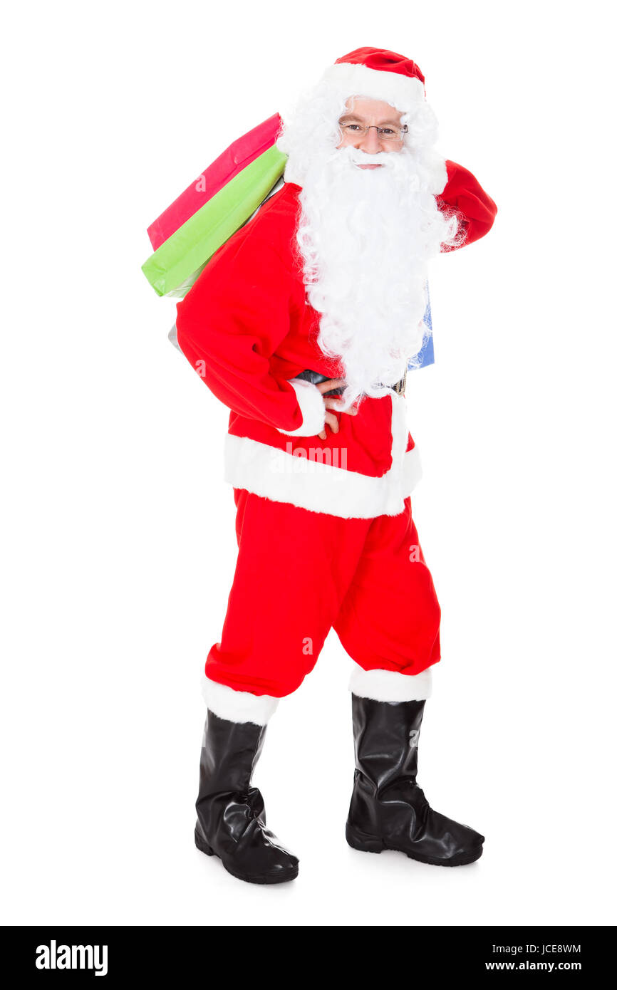 Portrait of santa holding shopping bag over white background Stock ...