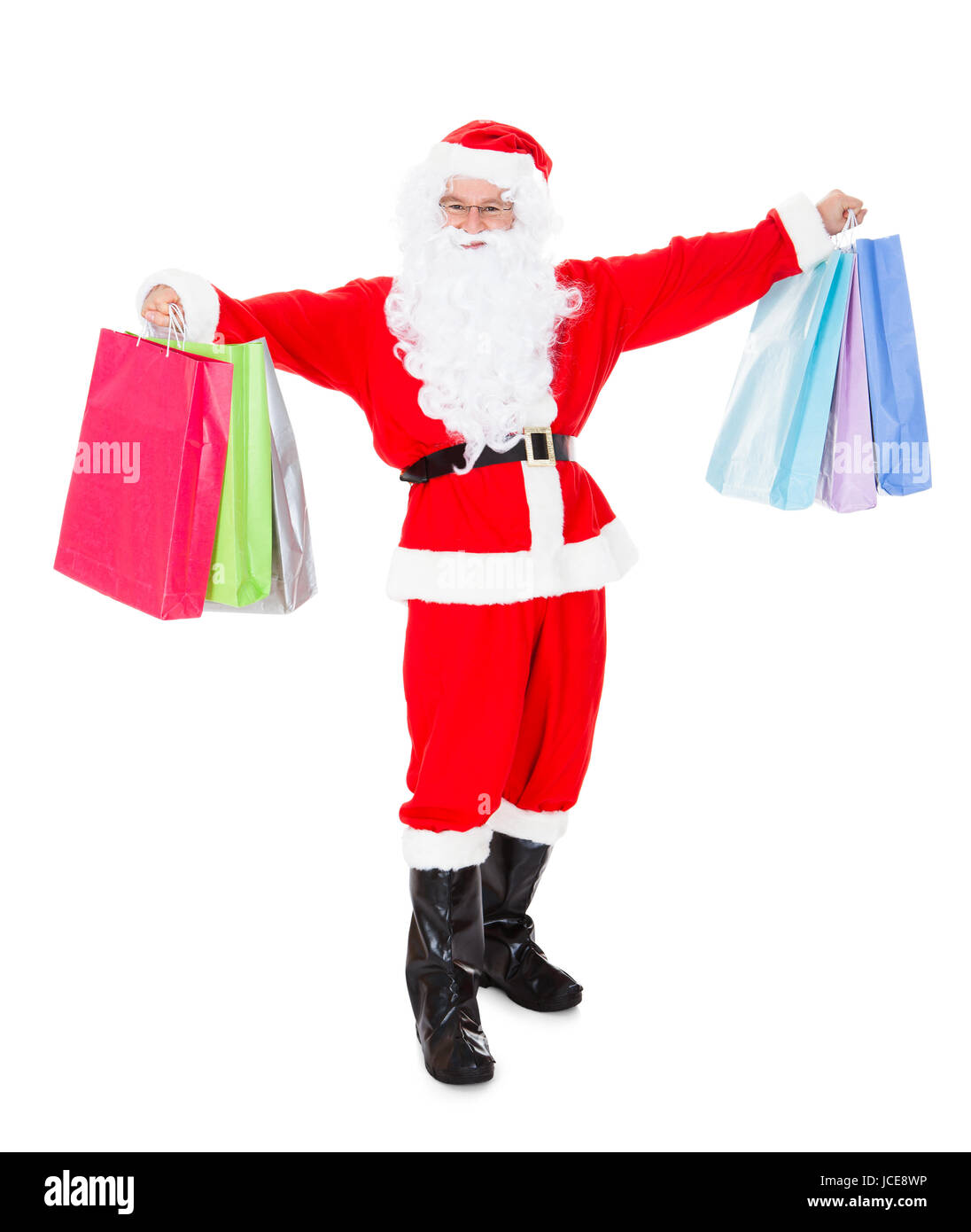 Portrait of santa holding shopping bag over white background Stock ...
