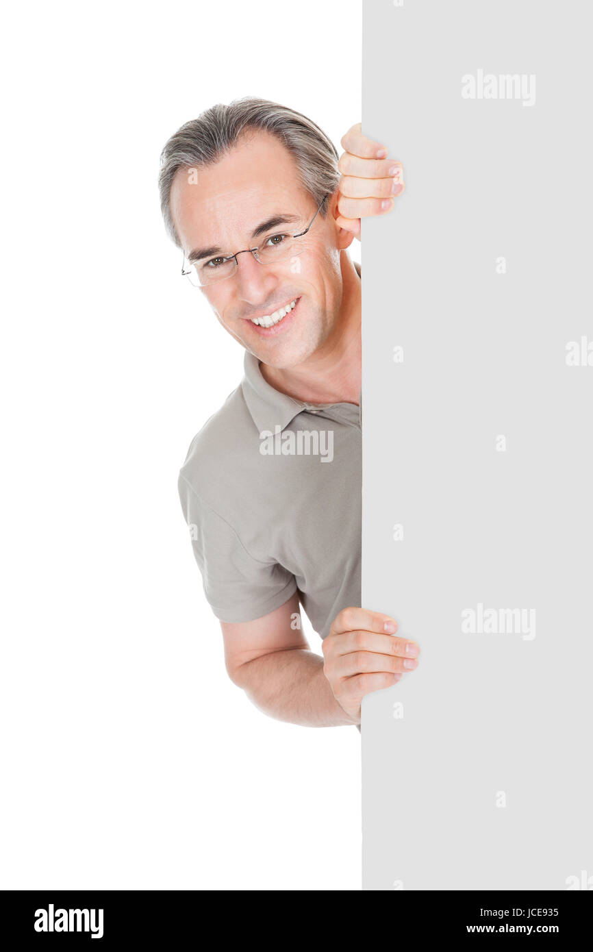 Happy Mature Man Standing Behind Placard isolated on White Background ...