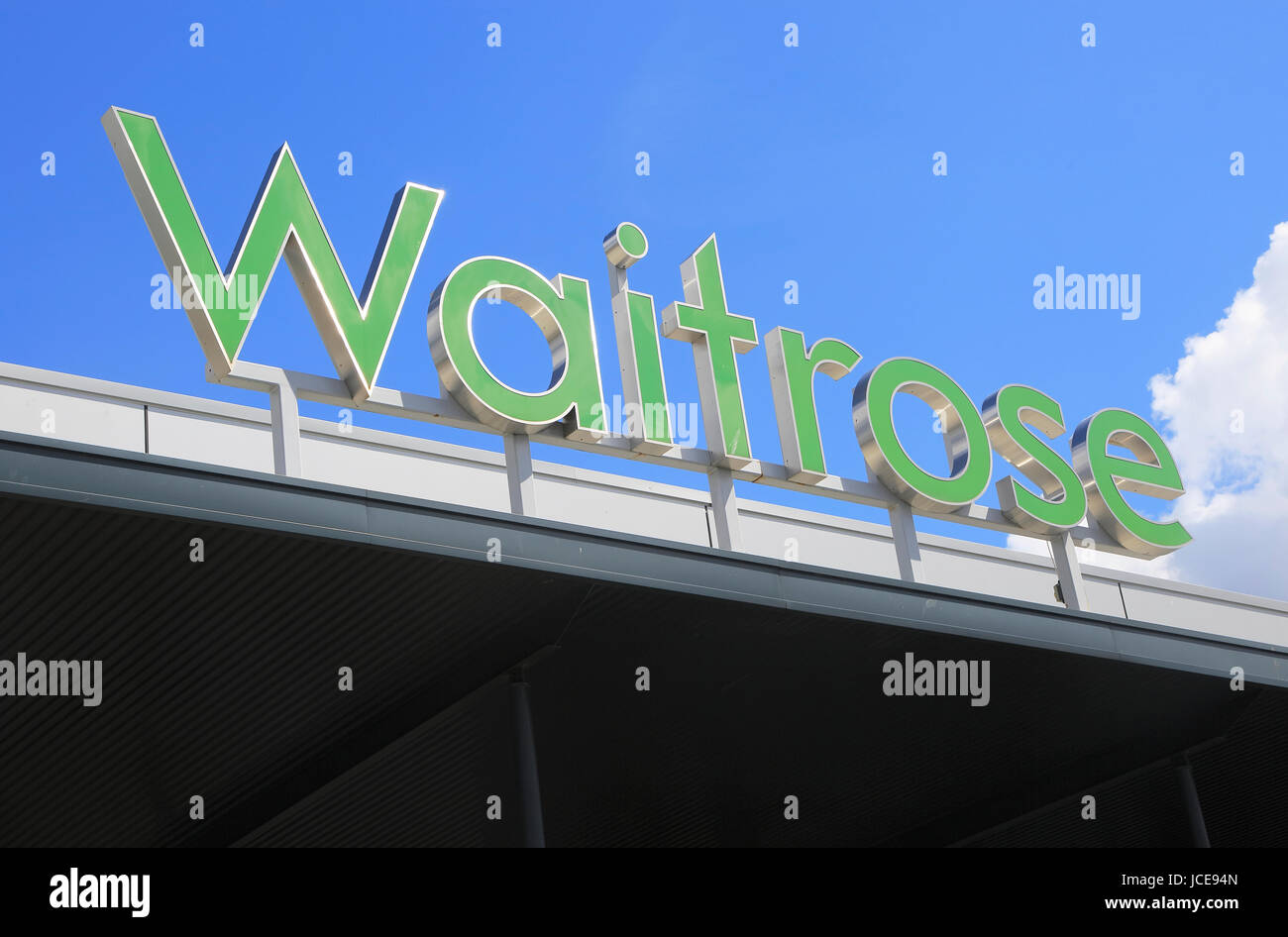 Green Waitrose supermarket shop sign against blue sky, Ipswich, Suffolk ...