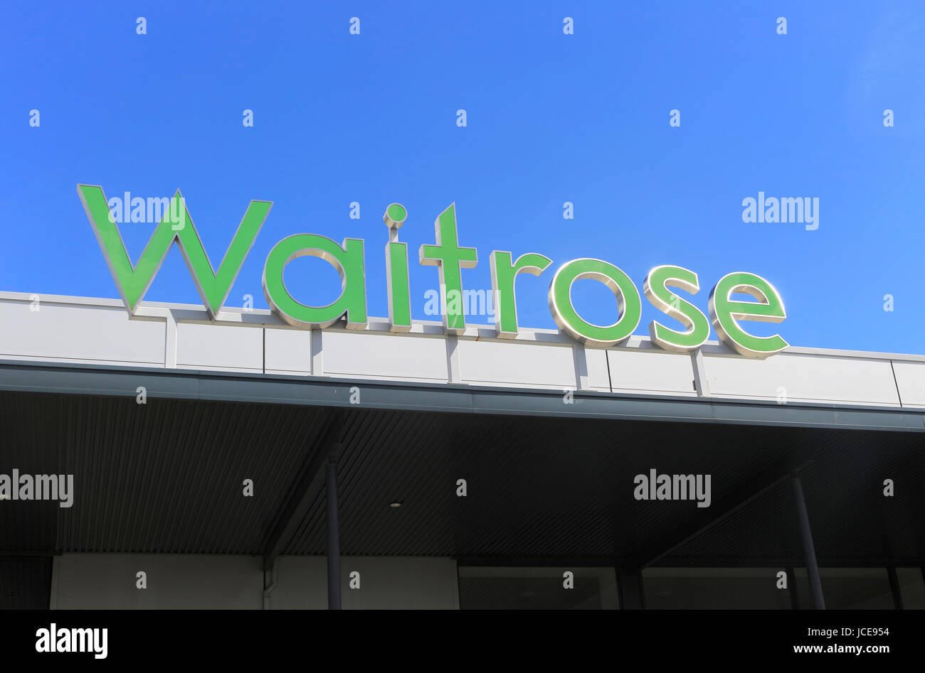 Green Waitrose supermarket shop sign against blue sky, Ipswich, Suffolk ...