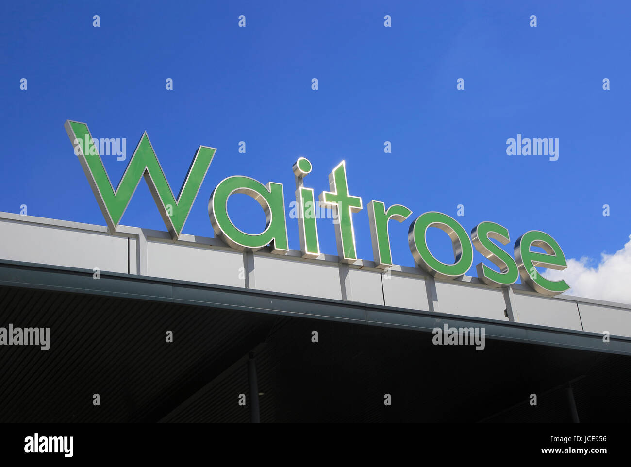 Green Waitrose supermarket shop sign against blue sky, Ipswich, Suffolk ...
