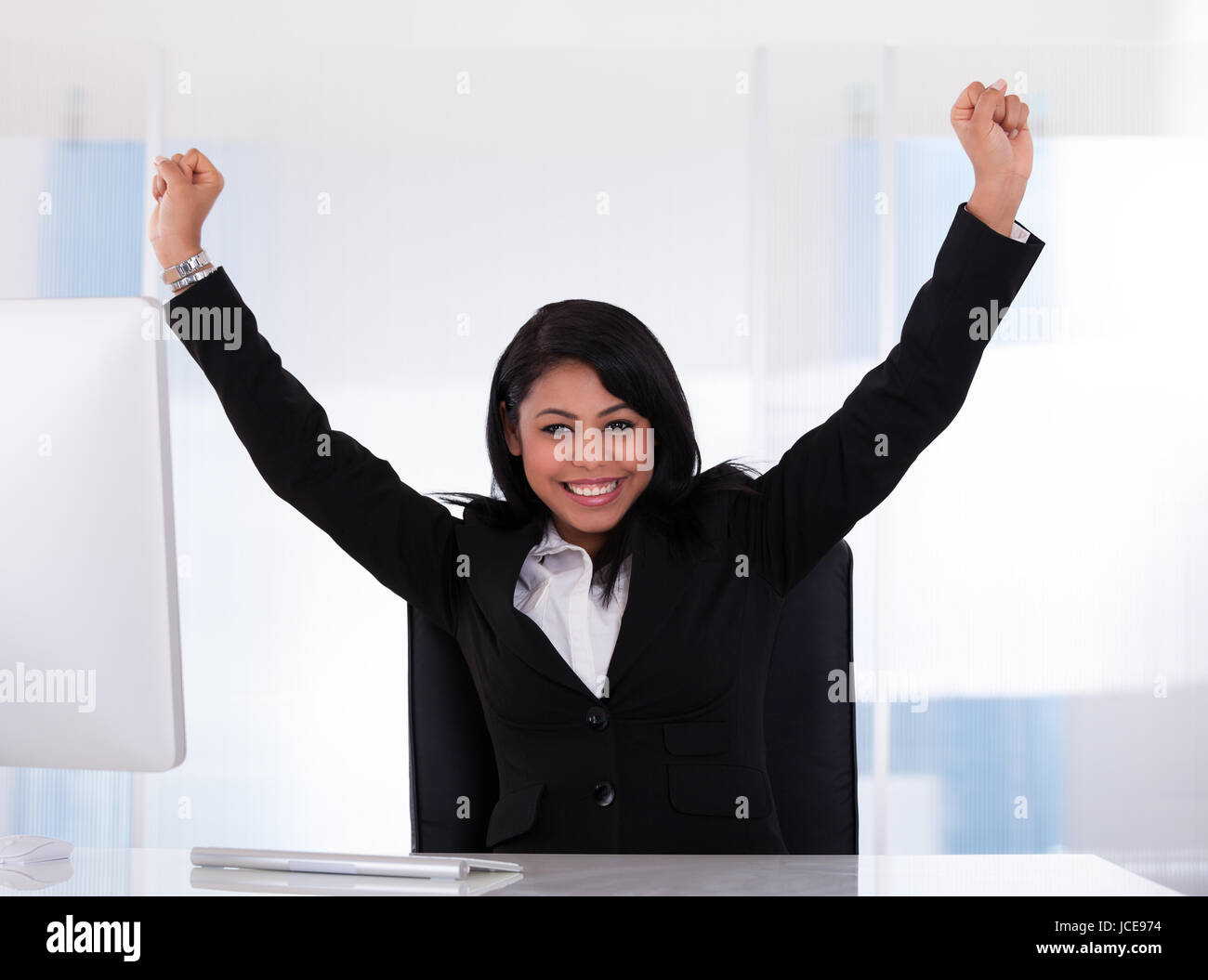 Portrait Of Happy Businesswoman With Hand Raised Stock Photo - Alamy