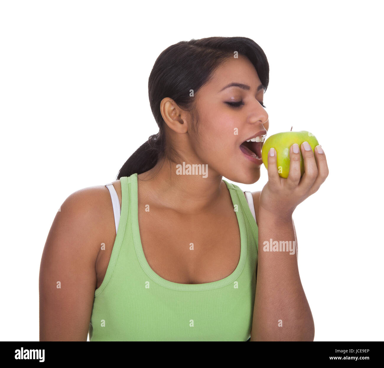 Young Woman Eating Apple Over White Background Stock Photo - Alamy