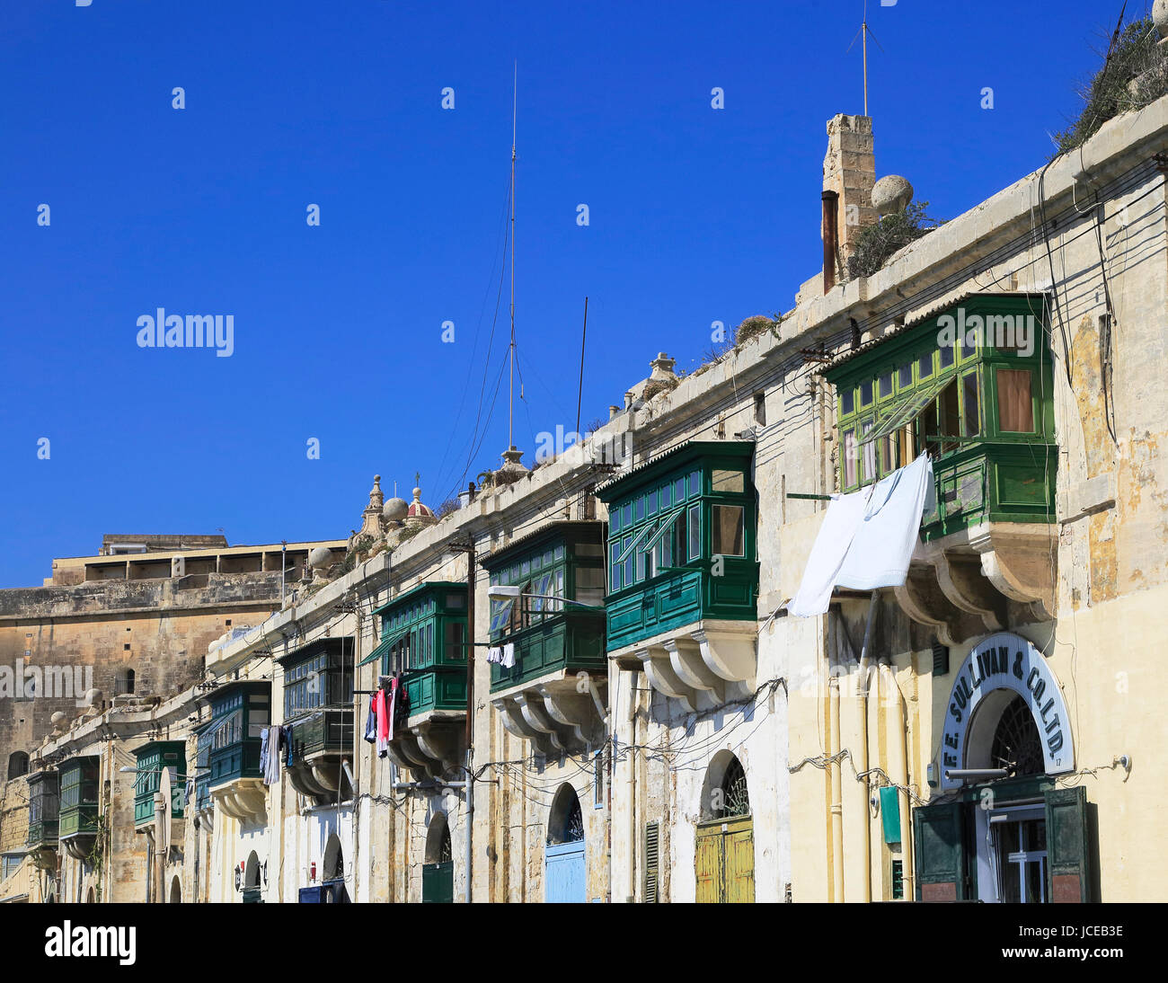 Old merchant house with balcony above warehouse area, Valletta, Malta ...