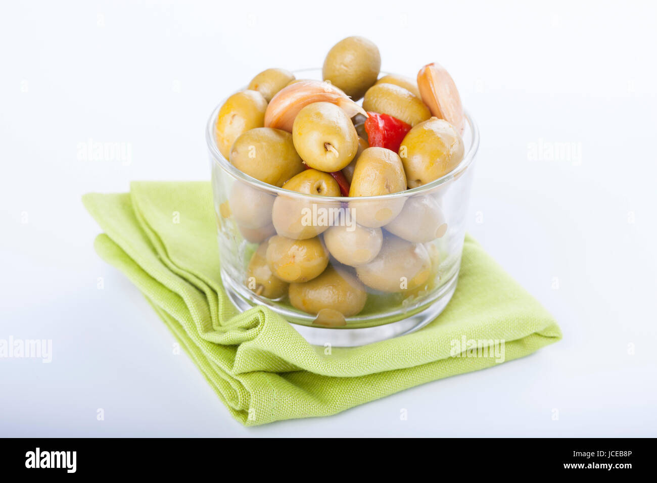 a handful of homemade olives on a glass, typical spanish tapa, isolated ...