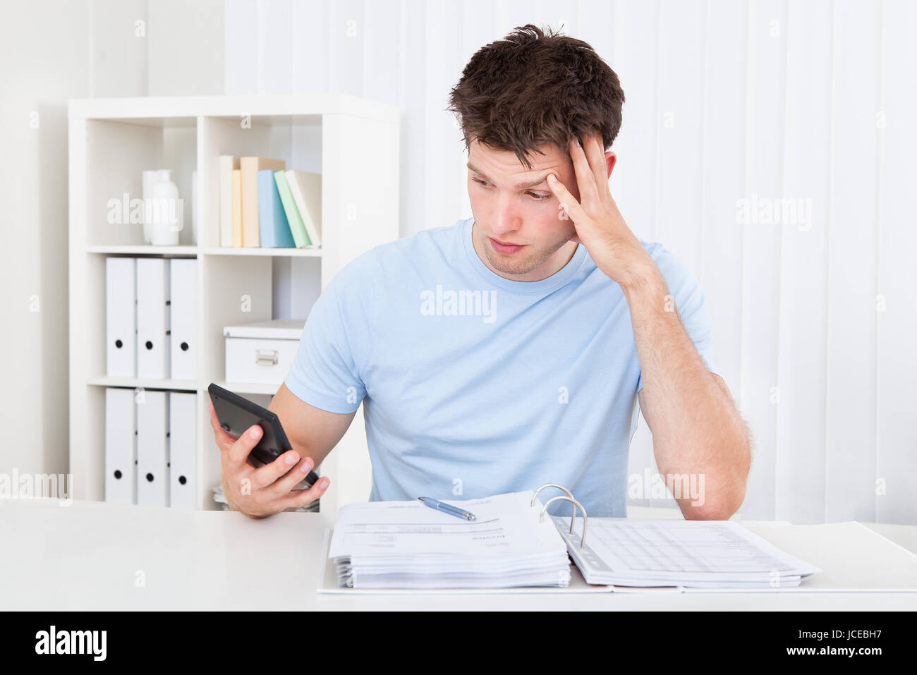 Young man having problems with his finances Stock Photo - Alamy