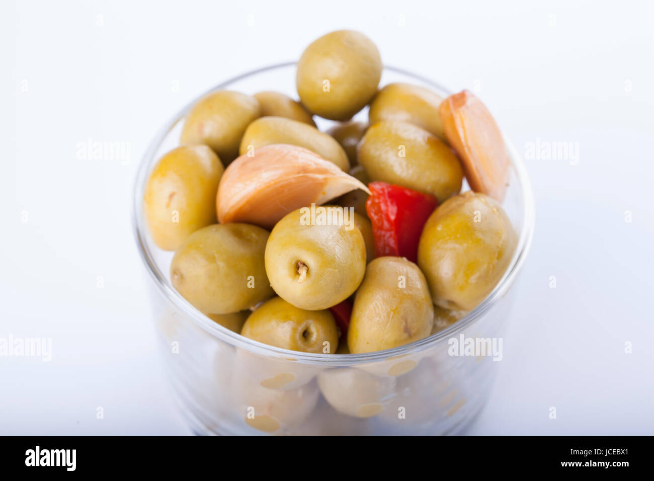 a handful of homemade olives on a glass, typical spanish tapa, isolated ...