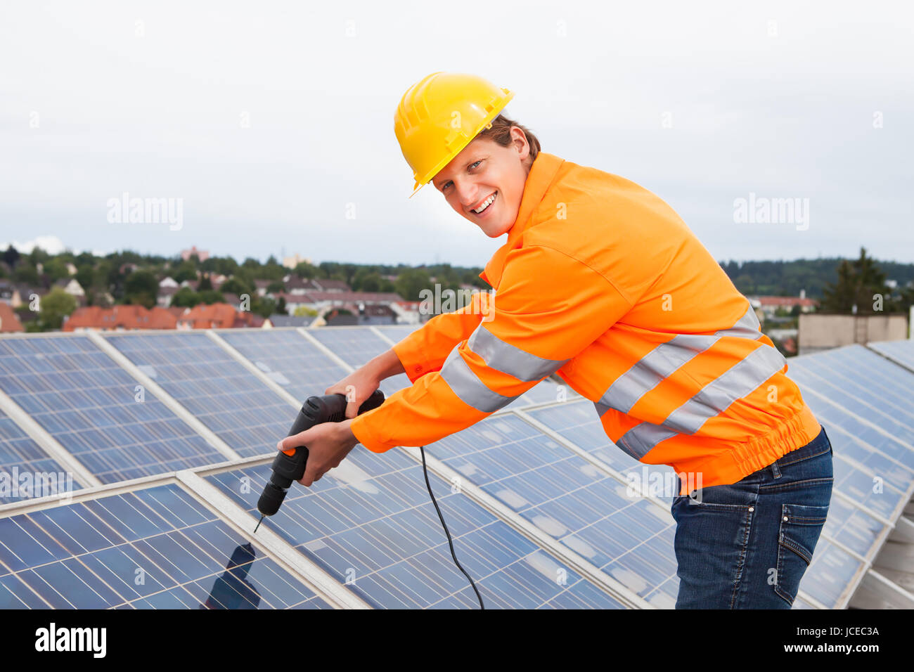 Male Engineer Fixing Solar Panels With Drill Machine Stock Photo - Alamy