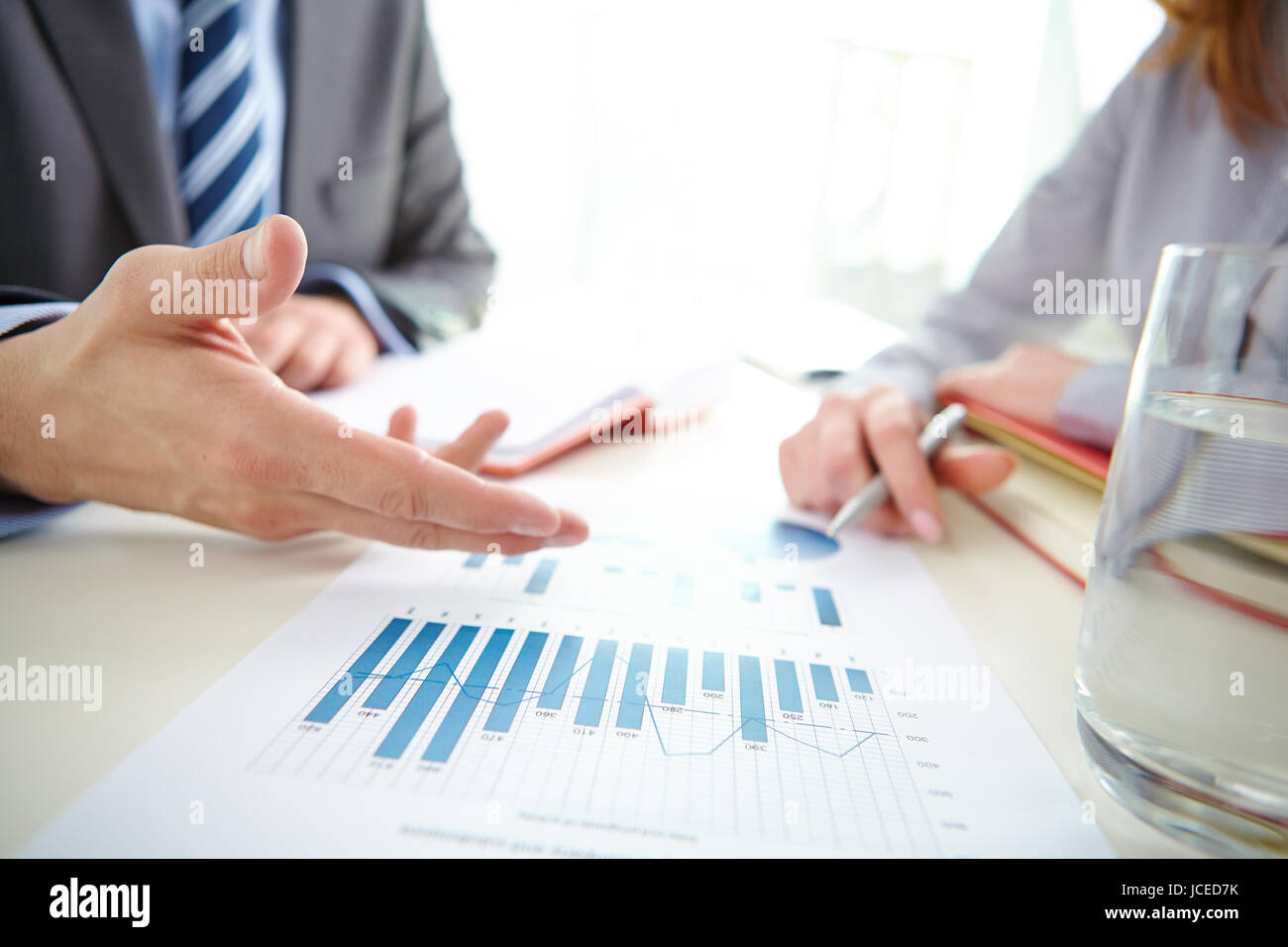 Businessman hand pointing at chart and graph during discussion Stock ...