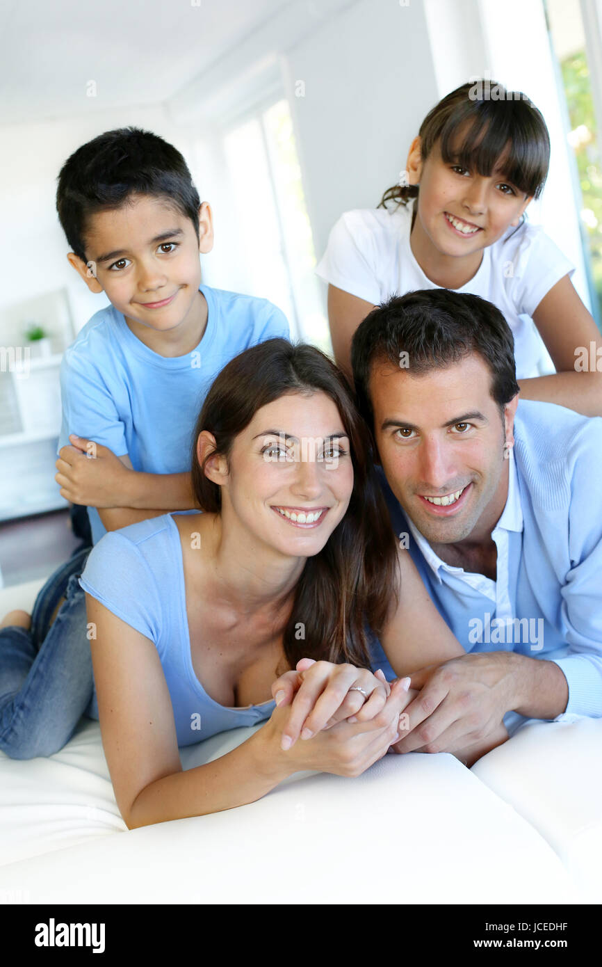 Portrait of happy family laying down bed Stock Photo - Alamy