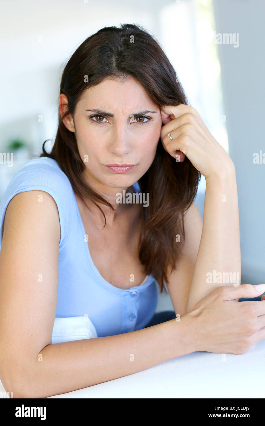 Closeup of brunette girl with upset look Stock Photo - Alamy