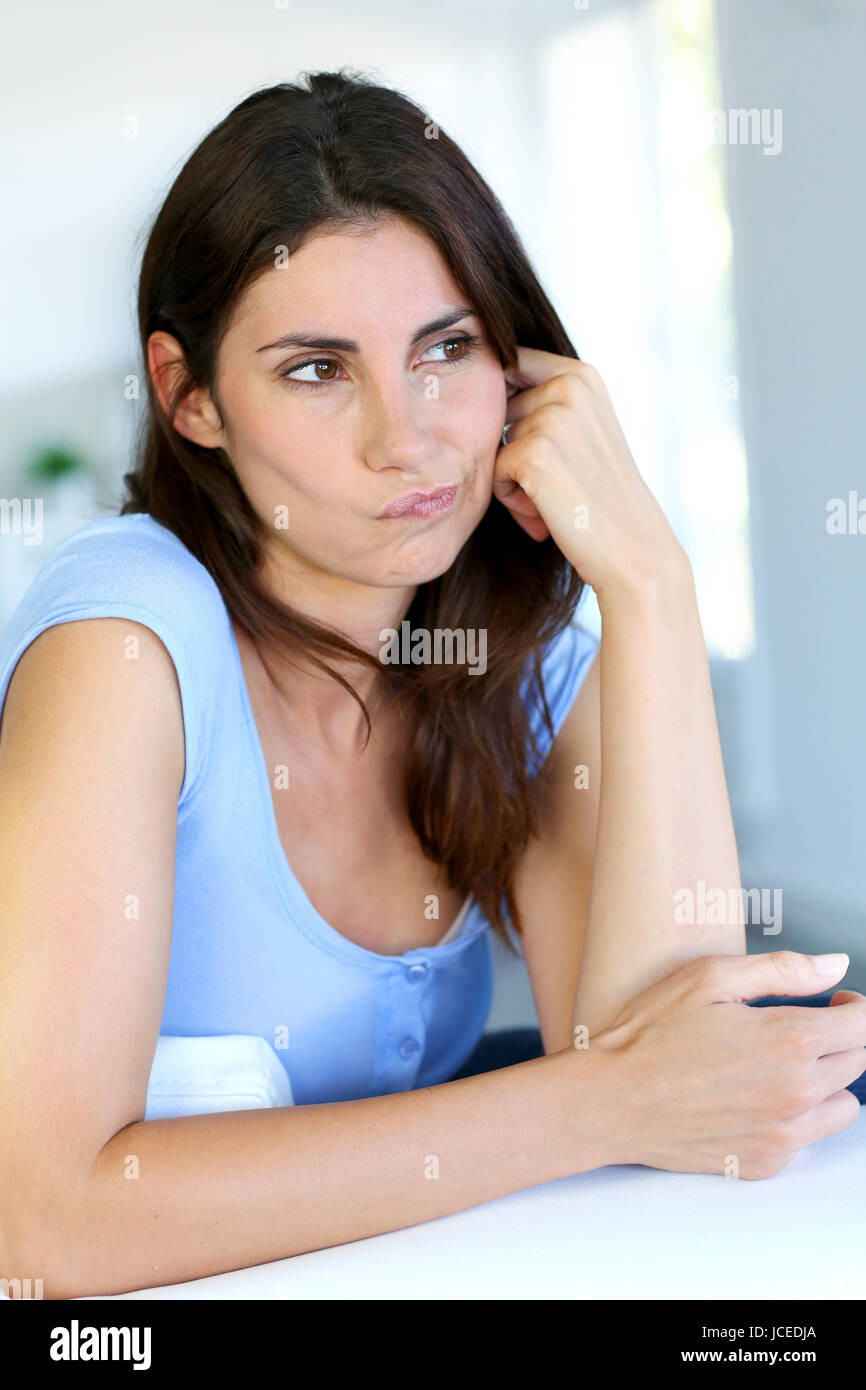 Closeup of brunette girl with upset look Stock Photo - Alamy