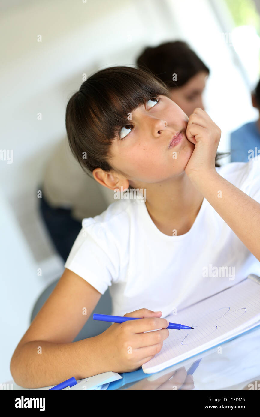 Closeup of schoolgirl in class with thoughtful look Stock Photo - Alamy