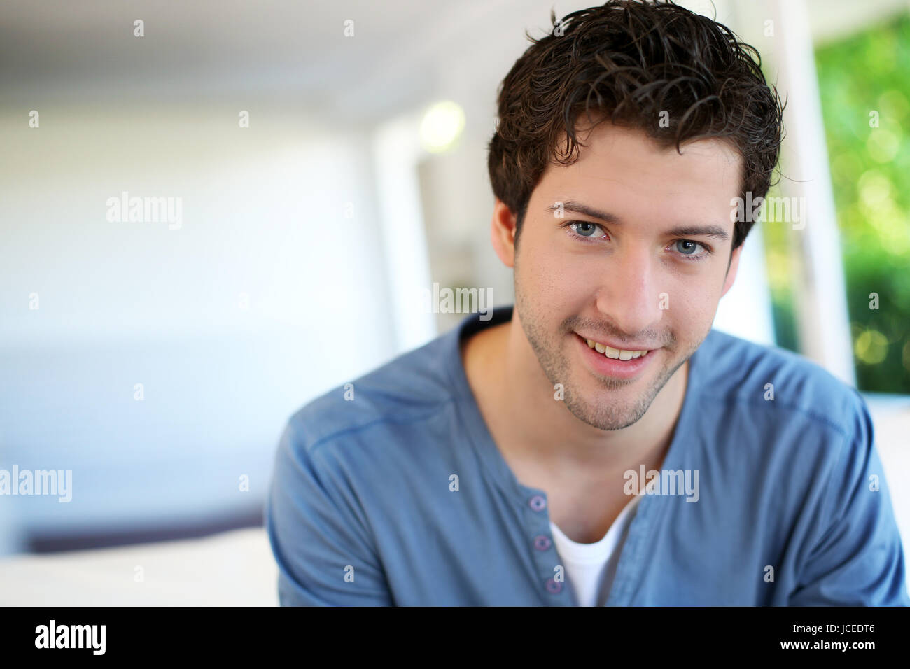 Portrait of cheerful young guy with blue eyes Stock Photo - Alamy
