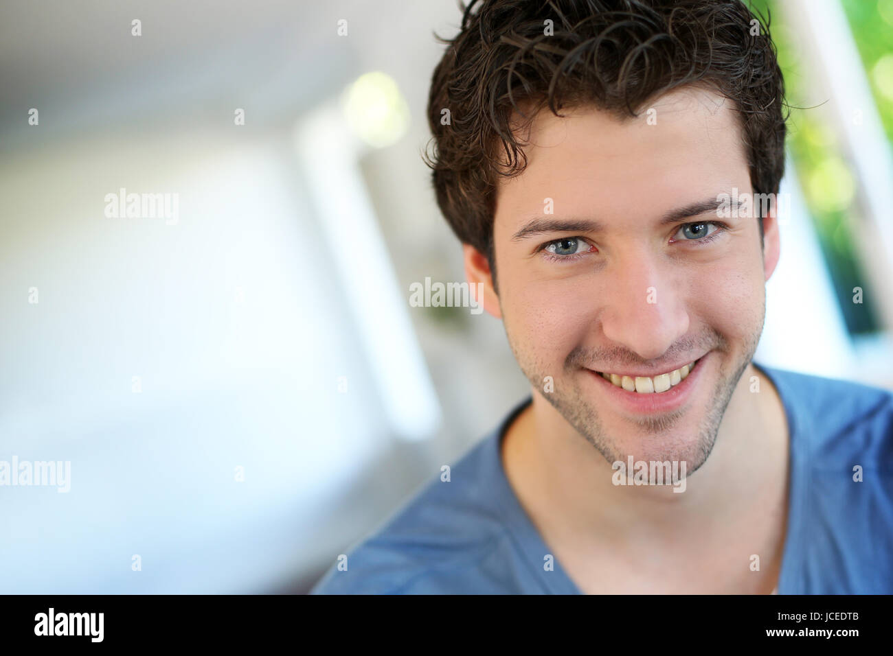 Portrait of cheerful young guy with blue eyes Stock Photo - Alamy