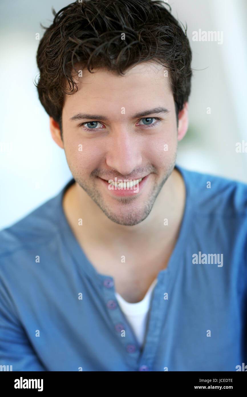 Portrait of cheerful young guy with blue eyes Stock Photo - Alamy