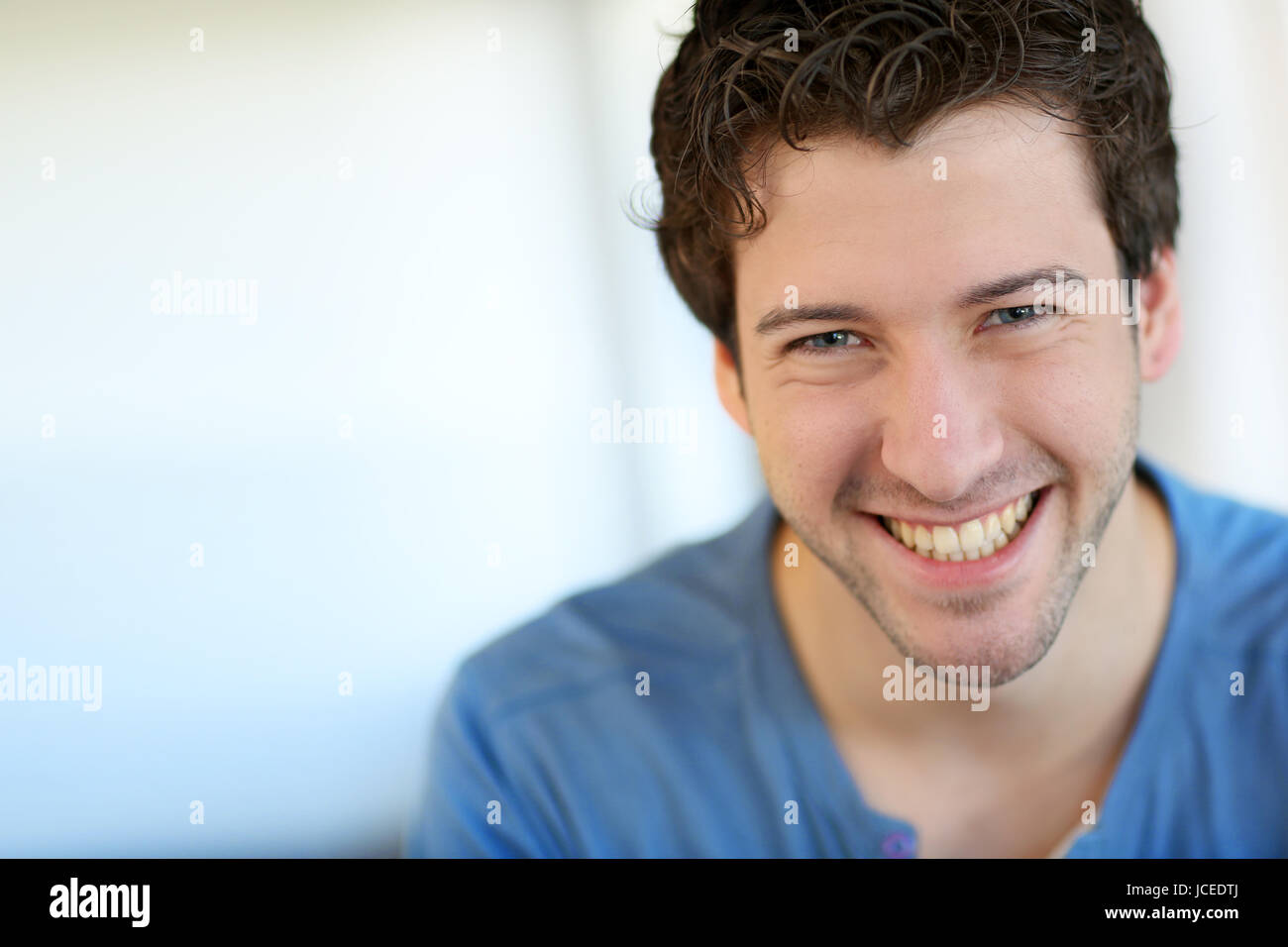 Portrait of cheerful young guy with blue eyes Stock Photo - Alamy