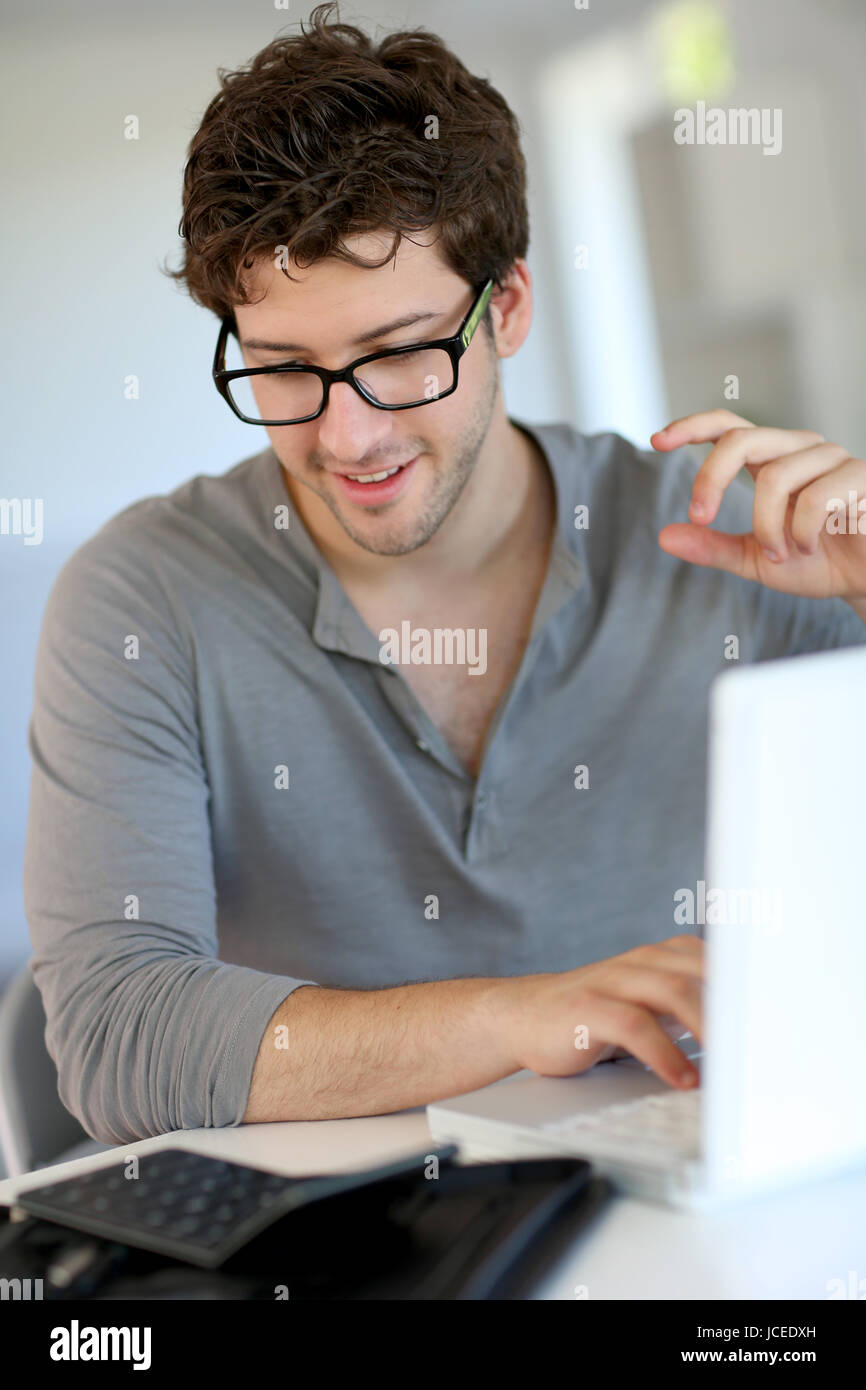 Young man studying from home Stock Photo - Alamy