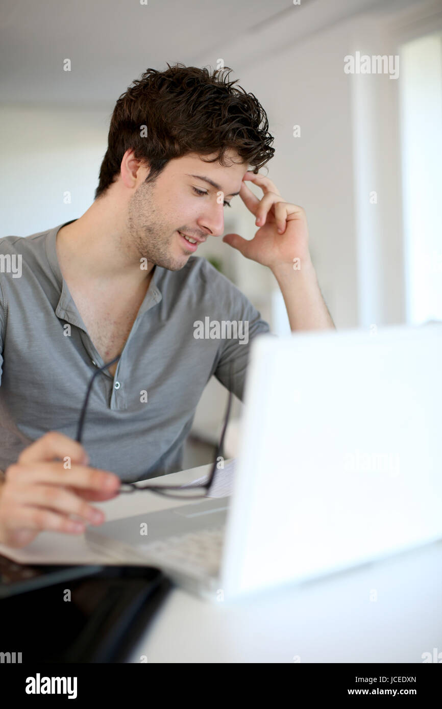 Young man studying from home Stock Photo - Alamy