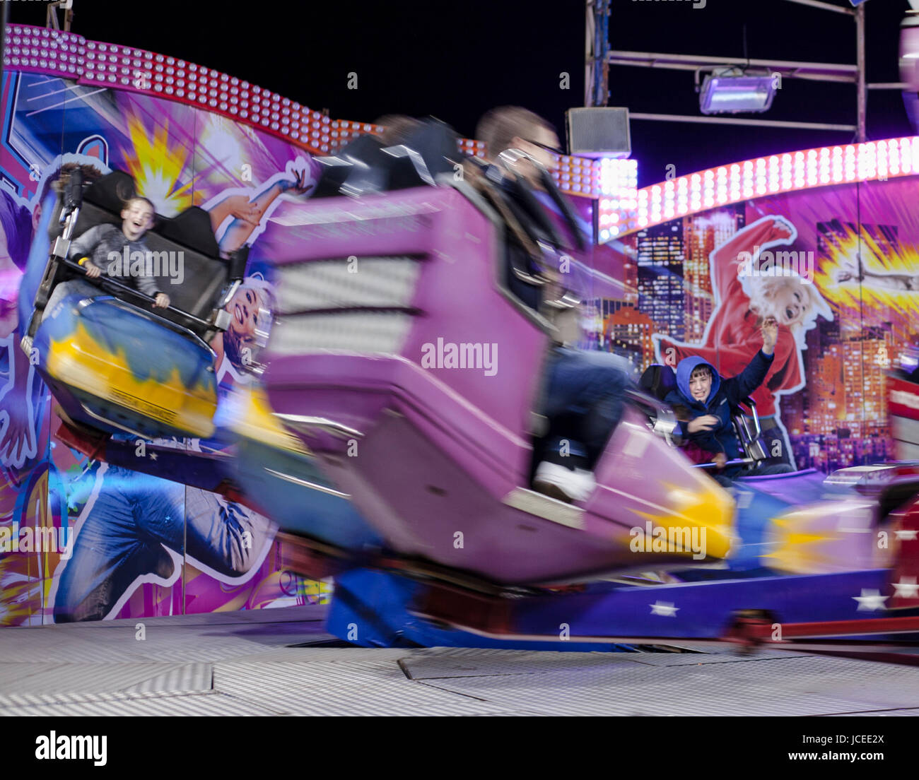Funfairs, rides, and amusement parks. Kids having fun on a funfair ride ...
