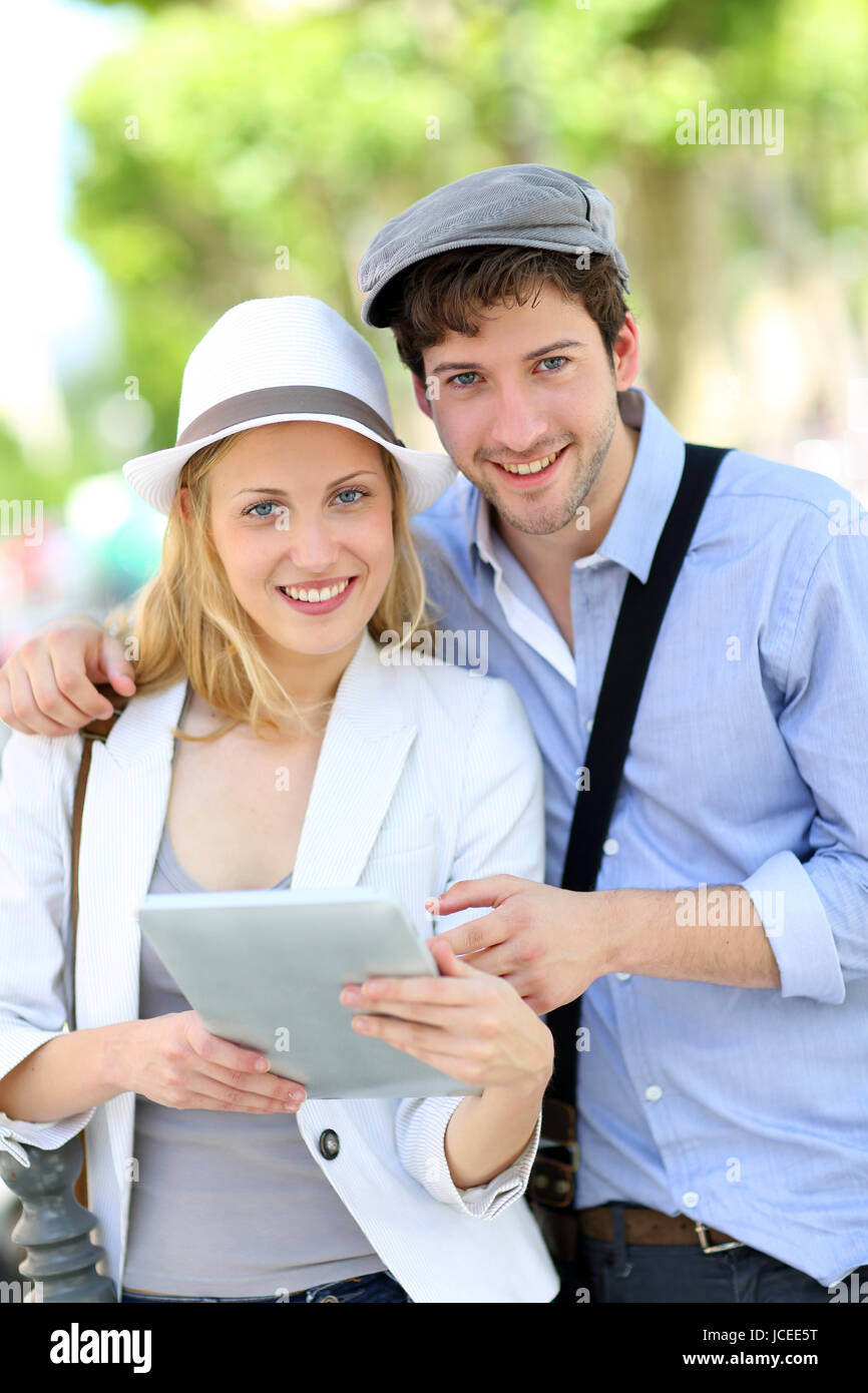Young couple in town using electronic tablet Stock Photo - Alamy