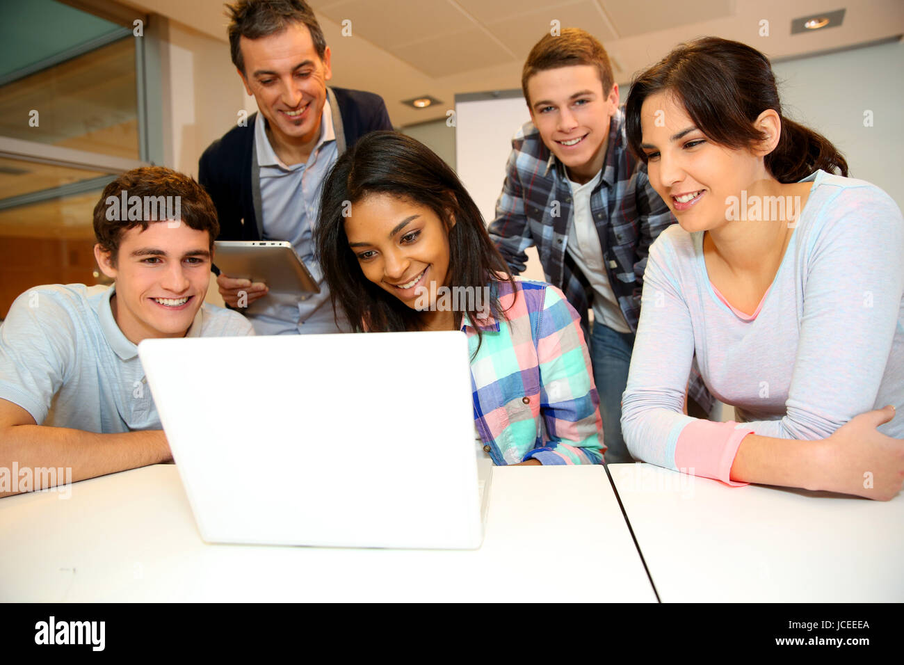 Group of students in computer training with teacher Stock Photo - Alamy