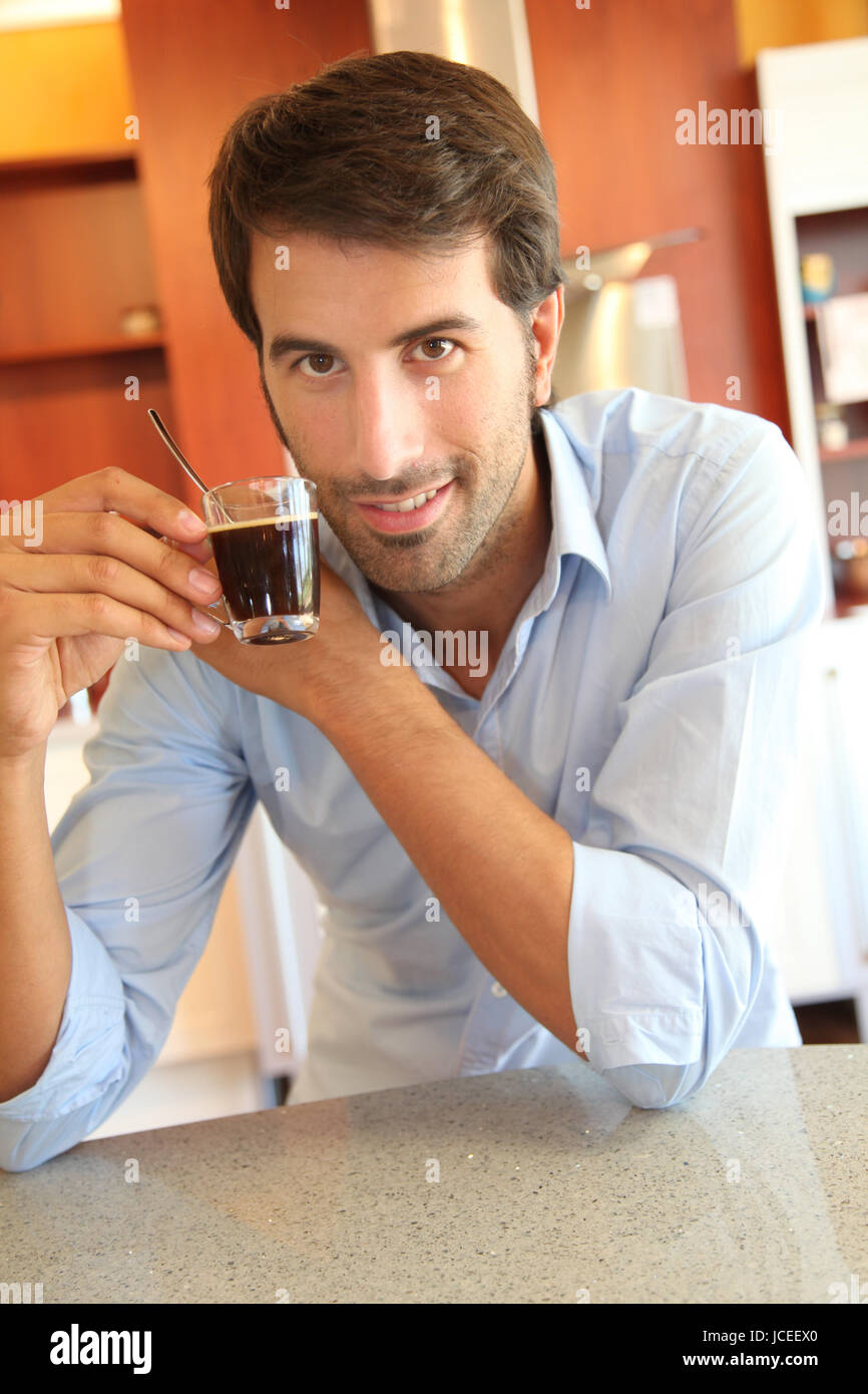 Handsome man having coffee at home Stock Photo - Alamy