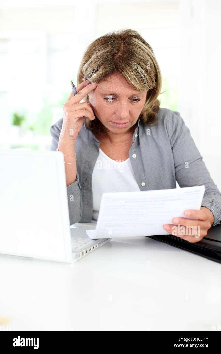 Senior woman having problems understanding official documents Stock ...