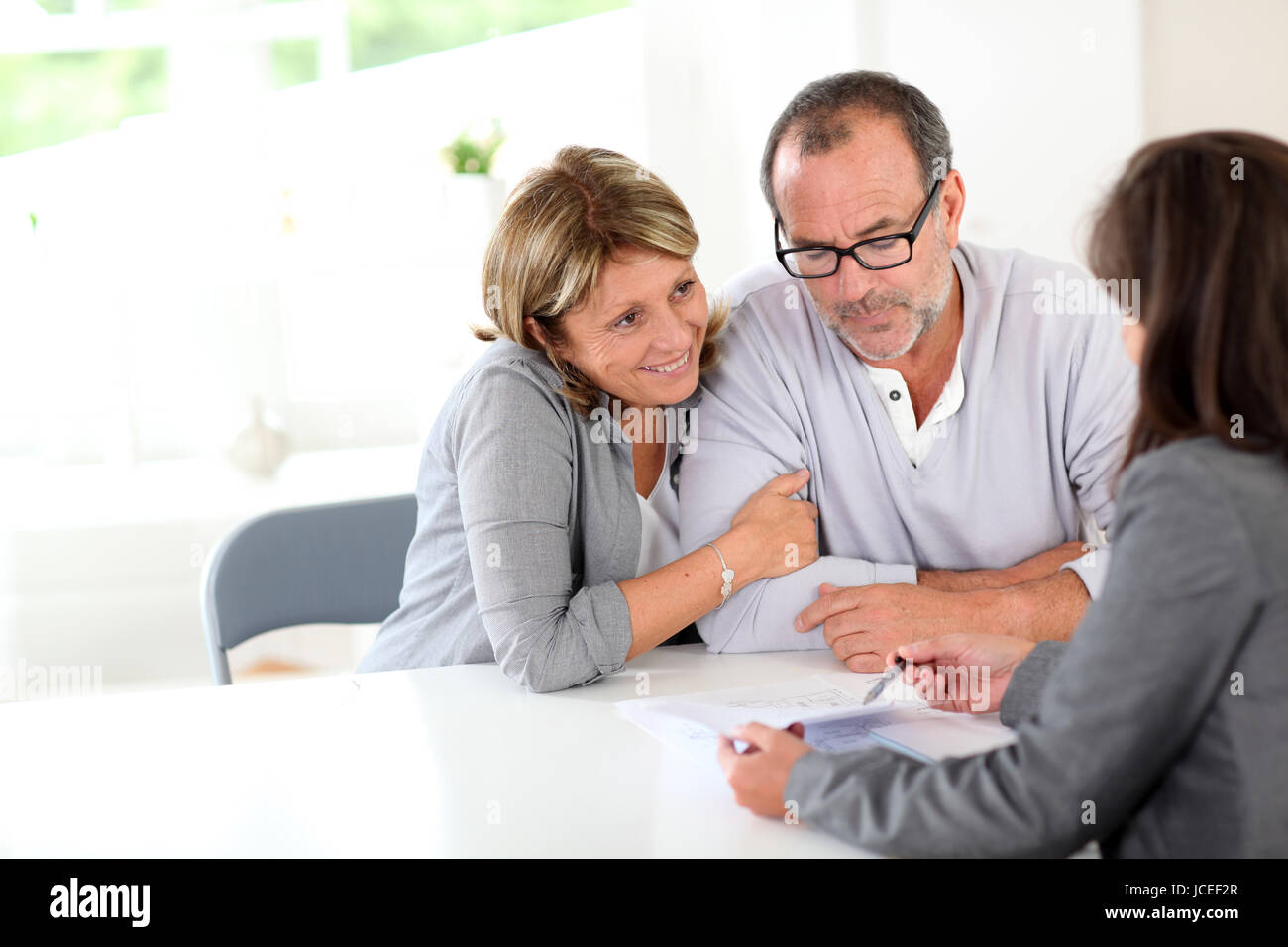 Senior couple signing financial contract Stock Photo - Alamy