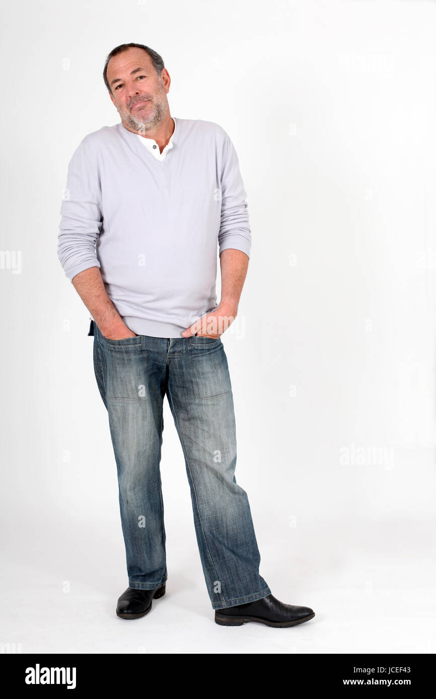 Senior man standing on white background with ignoring look Stock Photo ...