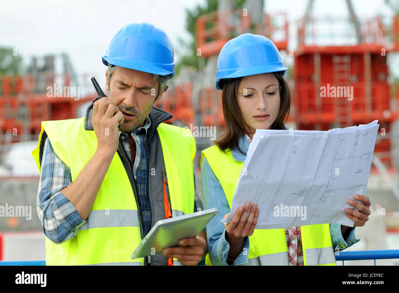 Engineers on building site controlling project Stock Photo - Alamy