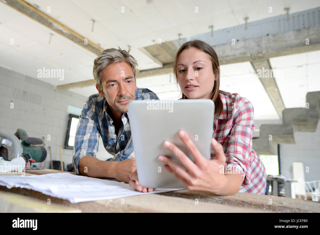Team of architects in house under construction Stock Photo - Alamy