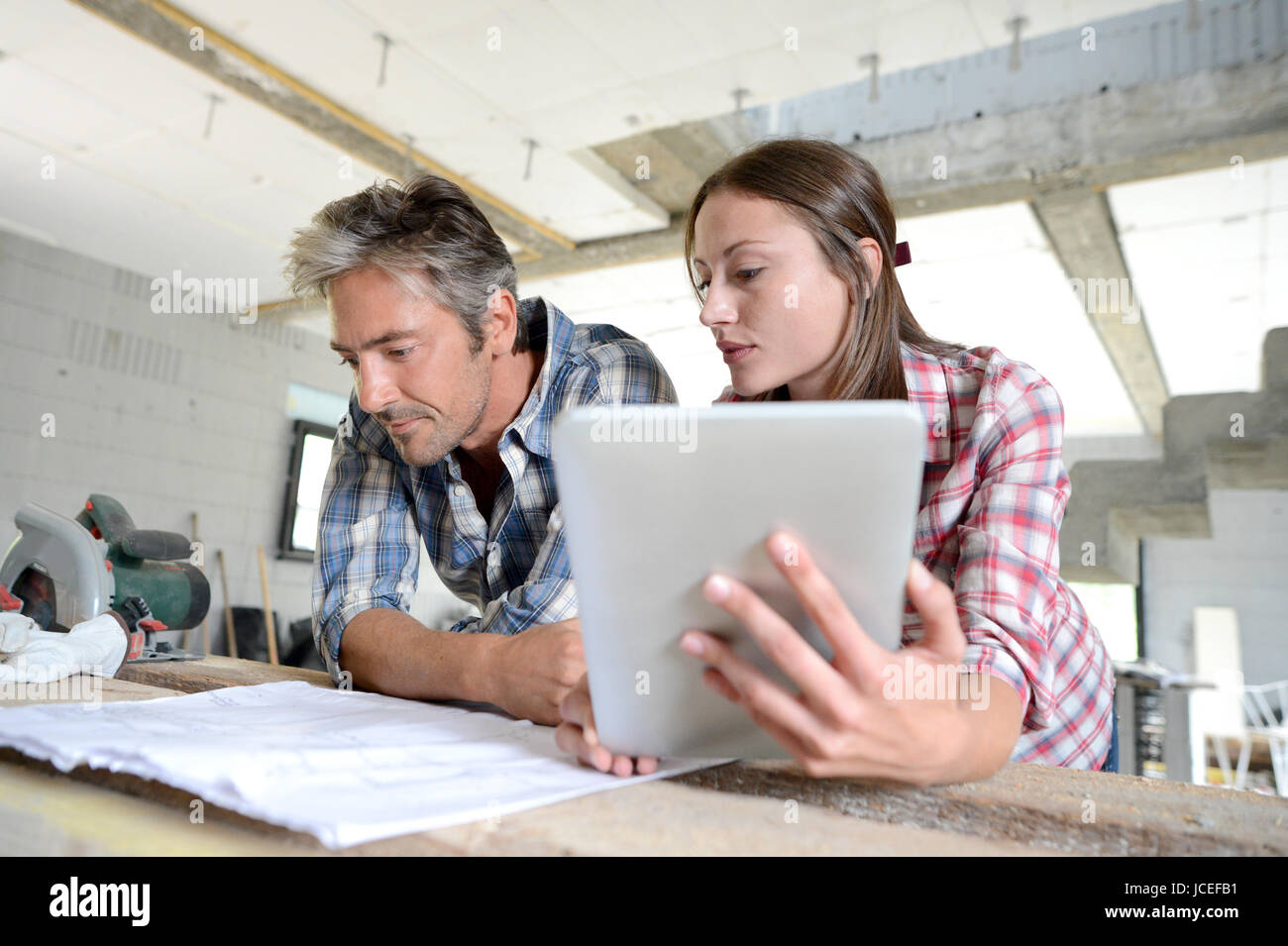 Team of architects in house under construction Stock Photo - Alamy