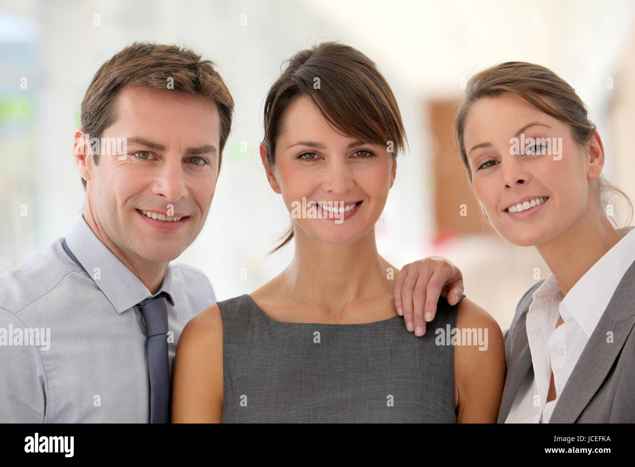 Cheerful business team standing in hallway Stock Photo - Alamy