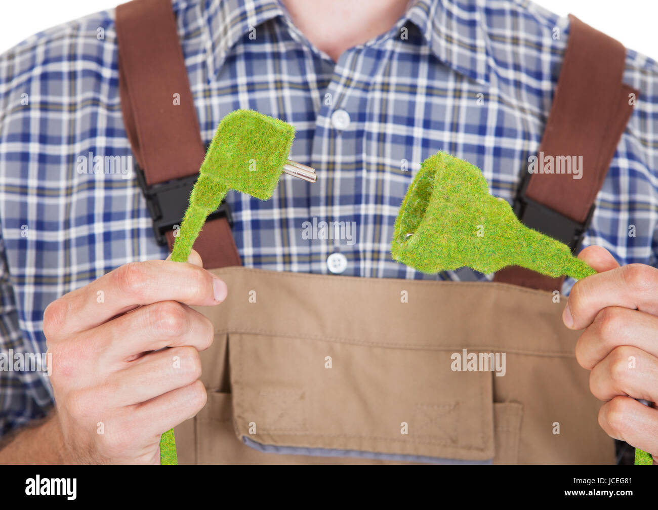 Close-up Of Architect Holding Grass Covered Electric Plug And Socket ...