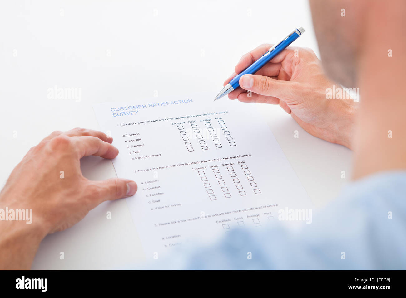 Close-up Of A Person Filling Survey Form With Pen Stock Photo - Alamy