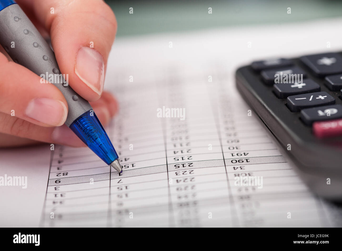 Close-up Of Hand Holding Pen With Calculator Stock Photo - Alamy