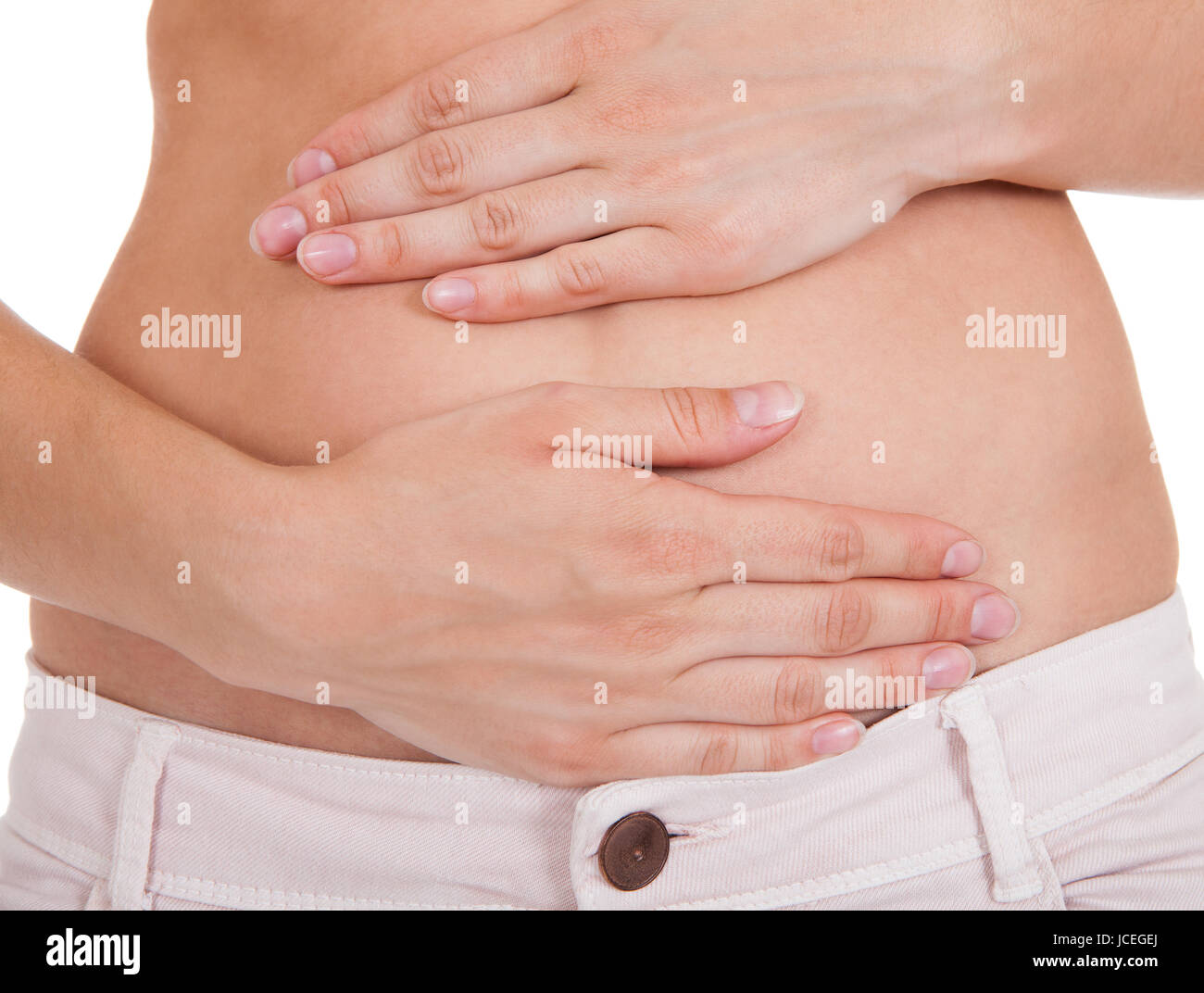 Close up of woman's hands on belly isolated on white background Stock Photo - Alamy