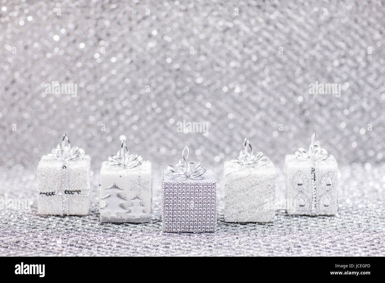 Miniatures of silver Christmas present boxes Stock Photo - Alamy