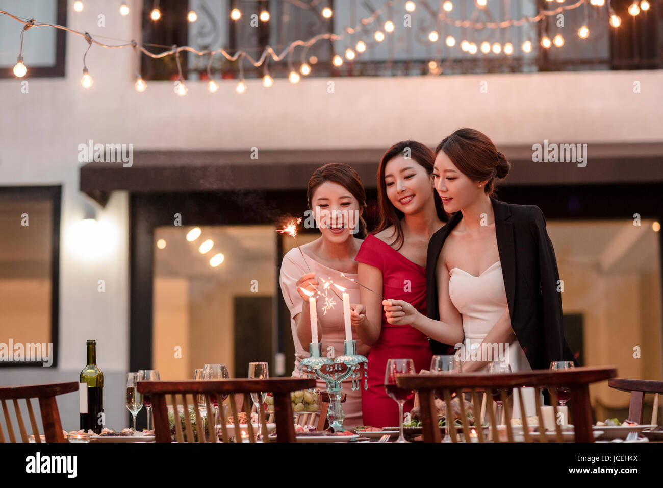 Three smiling women at party in garden Stock Photo - Alamy
